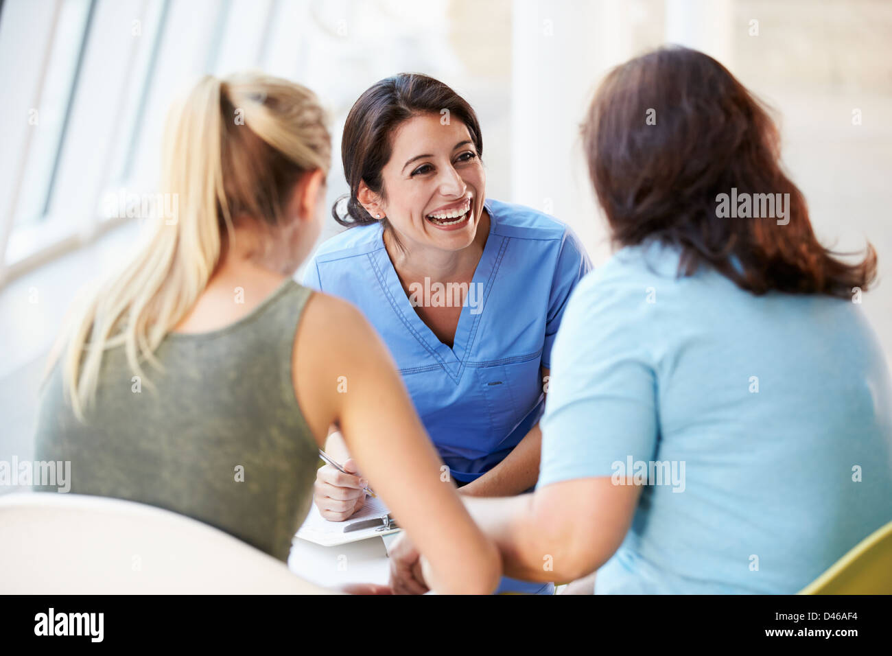 Nurse Meeting With Teenage Girl And Mother In Hospital Stock Photo - Alamy