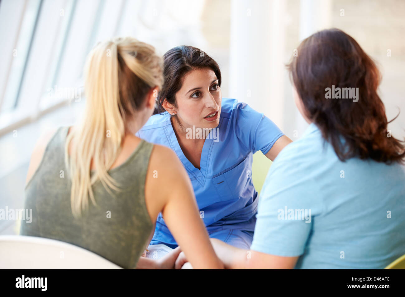 Nurse Meeting With Teenage Girl And Mother In Hospital Stock Photo - Alamy