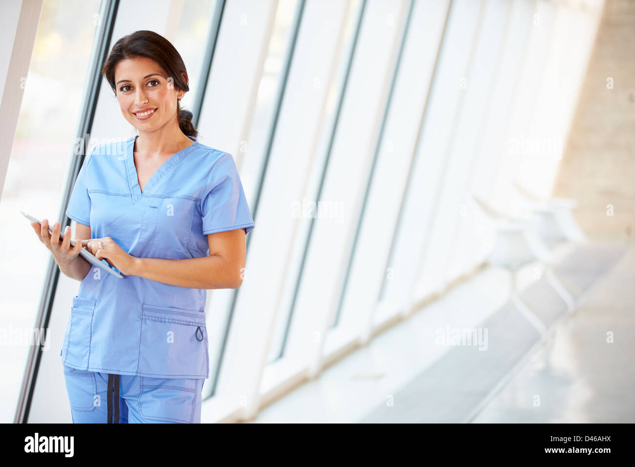 Nurse Using Digital Tablet In Corridor Of Modern Hospital Stock Photo ...