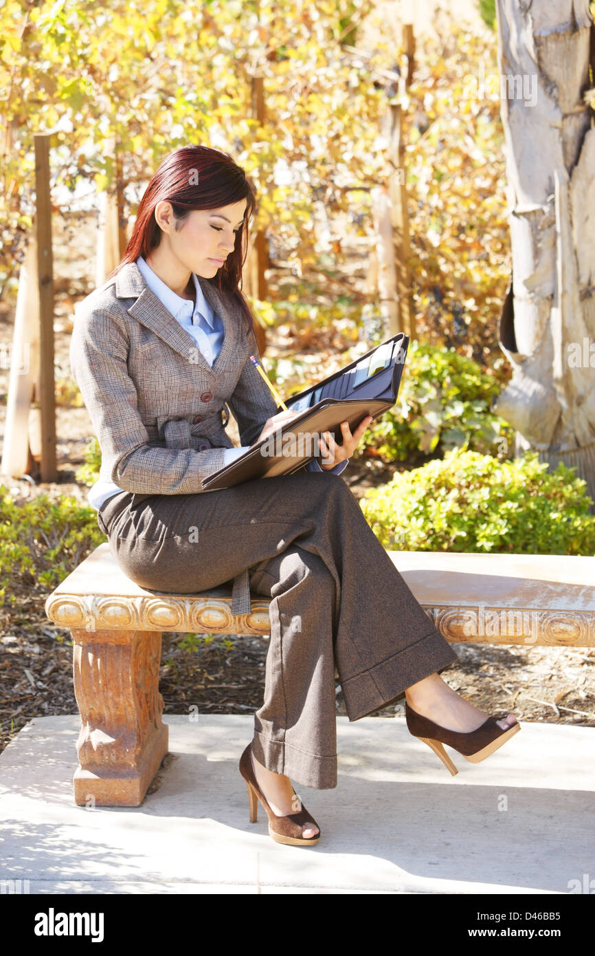 Business woman taking notes outside Stock Photo - Alamy