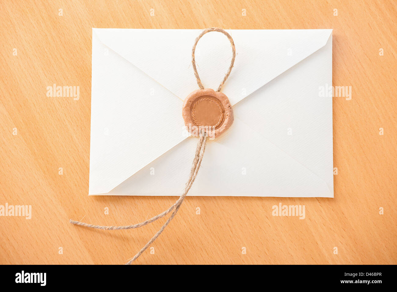 White envelope on wooden table Stock Photo - Alamy