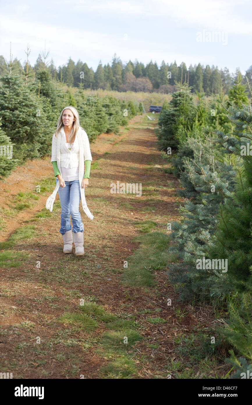 Woman wondering threw christmas tree hi-res stock photography and ...