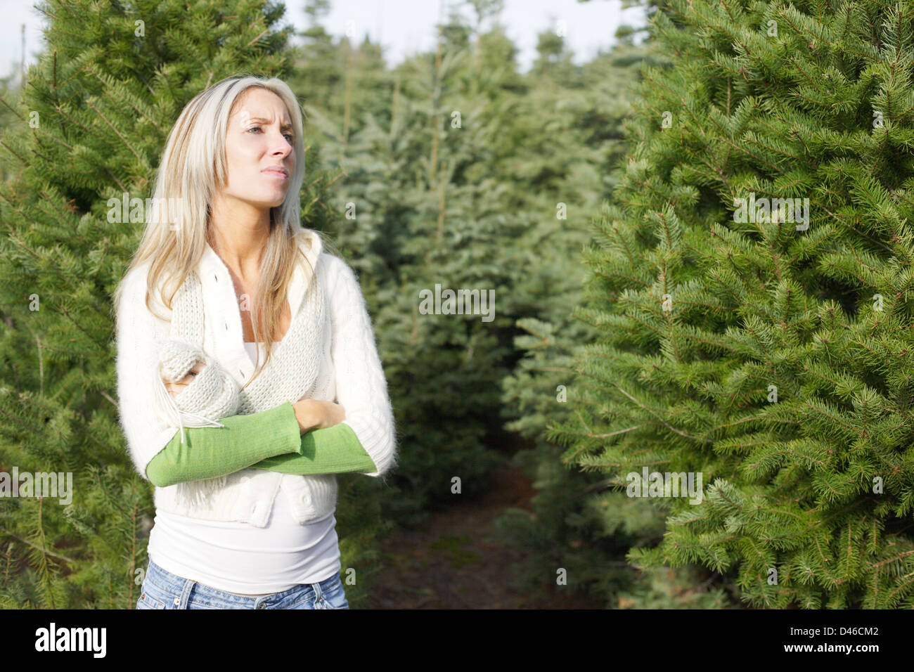 Woman wondering threw christmas tree hi-res stock photography and ...