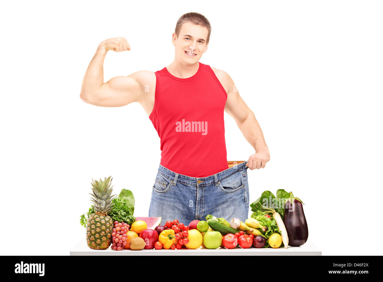 Weight loss man showing his muscles and standing behind a pile of ...