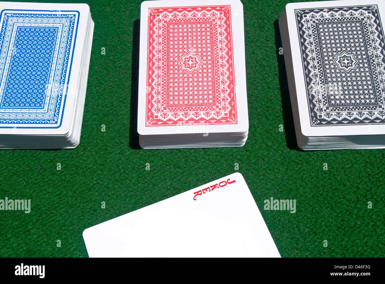 Shot of three complete different-color poker cards decks with a red ...