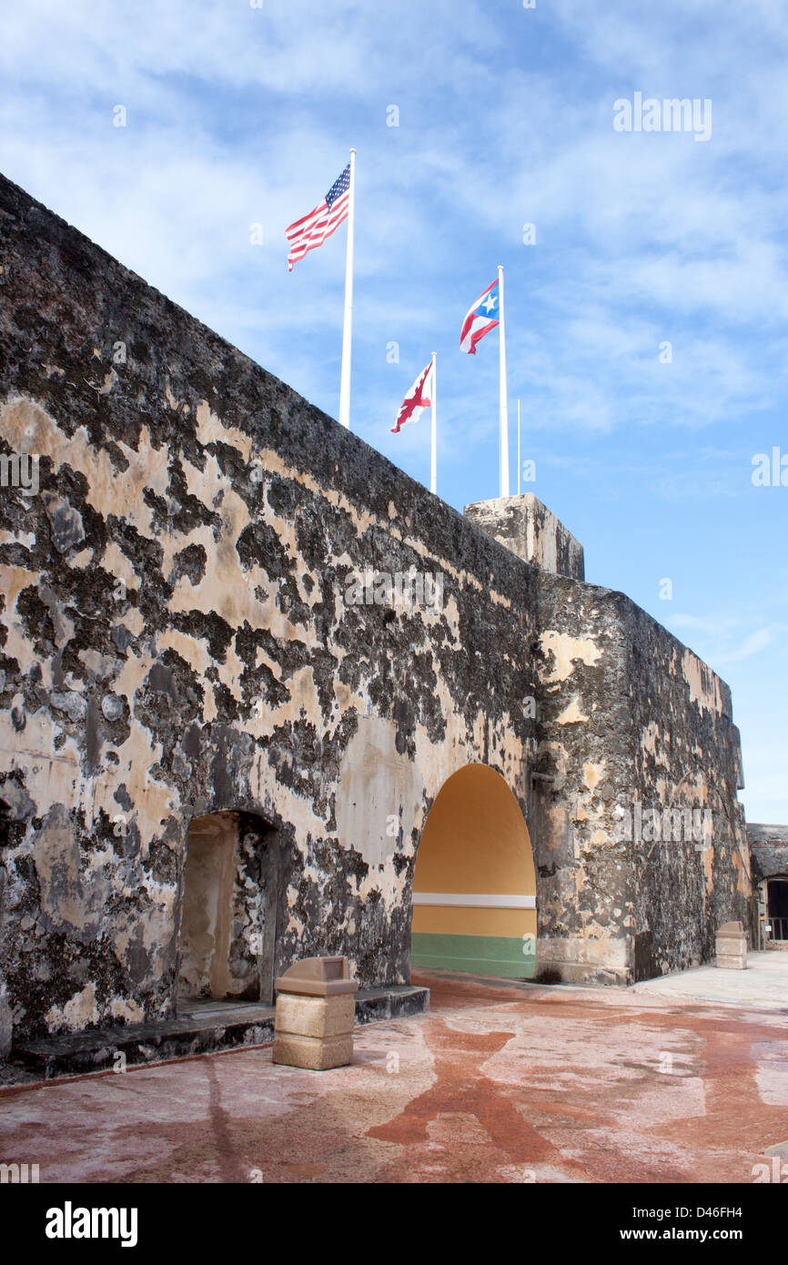 United States, Puerto Rico and Spanish Army Flags flying over Castillio ...