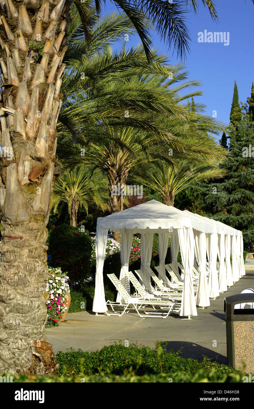 White tents at a tropical resort pool side Stock Photo - Alamy