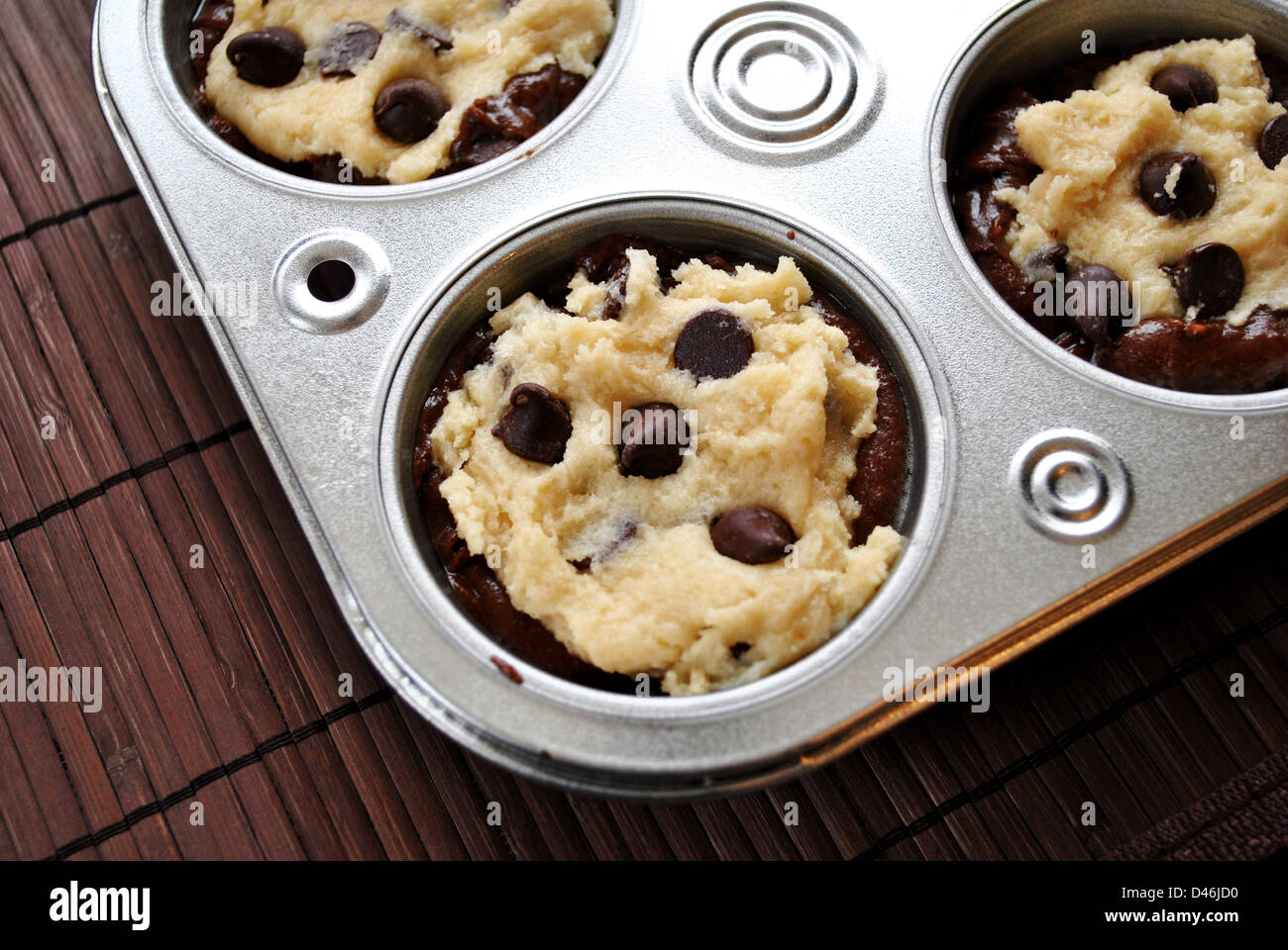 Raw Chocolate Muffin Mix in a Muffin Tin Stock Photo - Alamy
