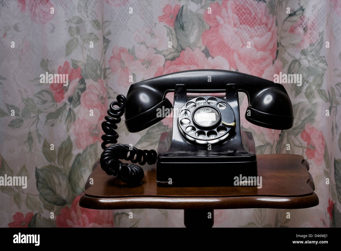 In front of her a black old rotary dial telephone hi-res stock ...