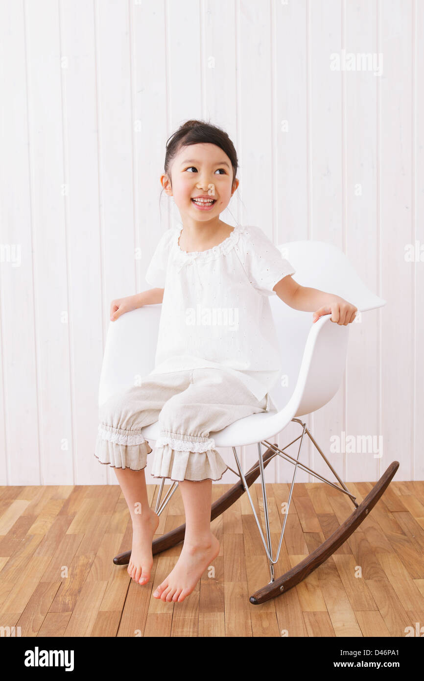 Girl Sitting On Chair Stock Photo - Alamy