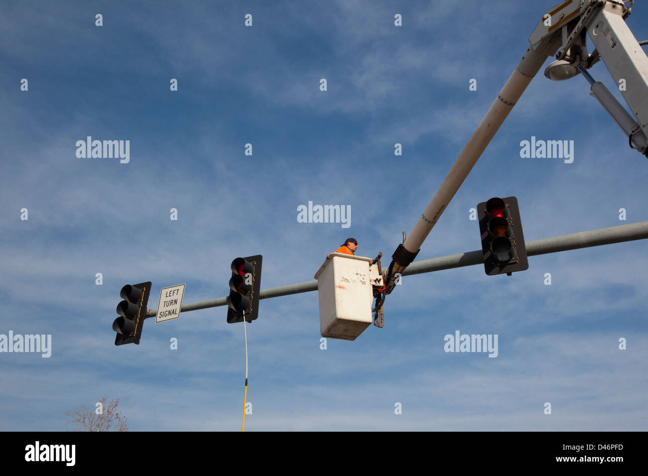 Utility workers in cranes working on power line poles Stock Photo - Alamy