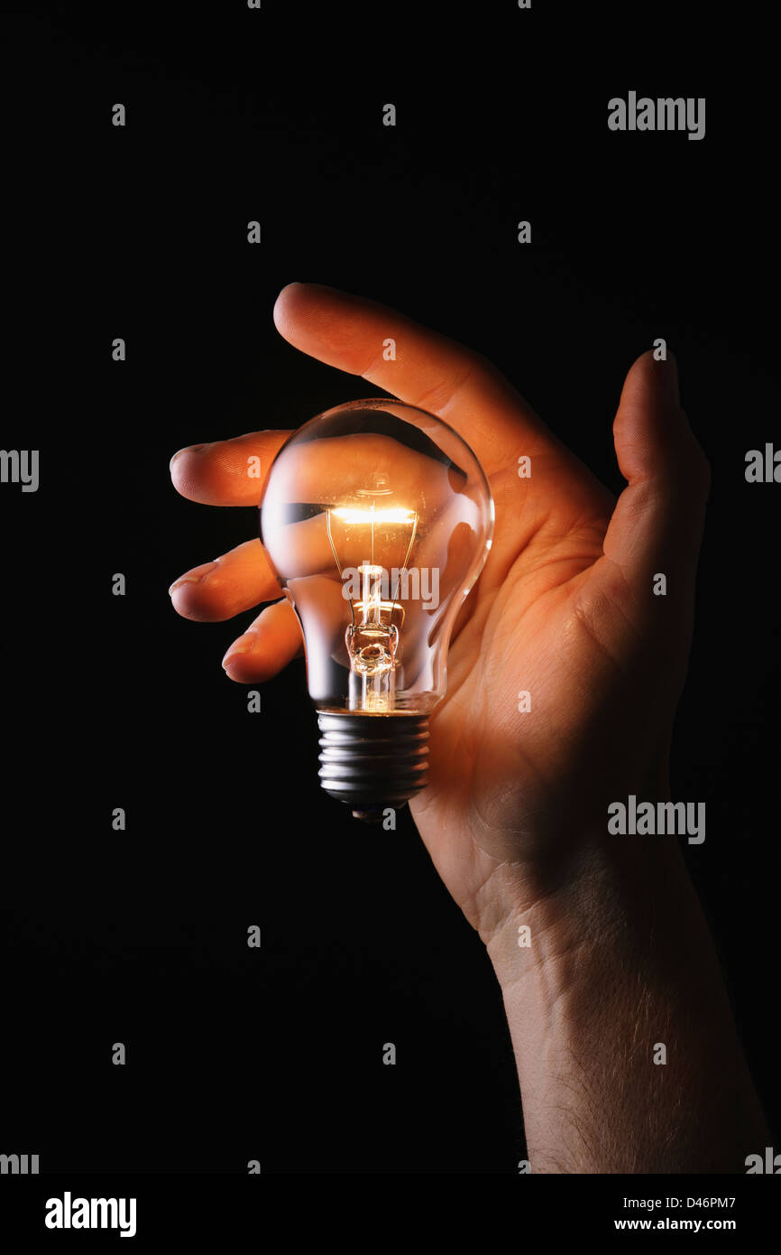 Hand With Light Bulb Stock Photo - Alamy