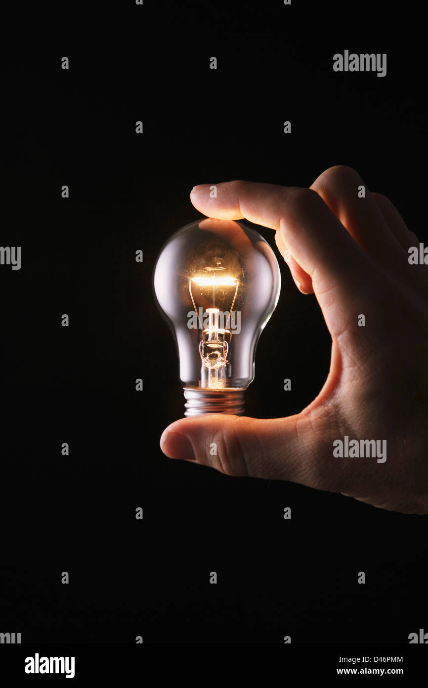 Hand With Light Bulb Stock Photo - Alamy