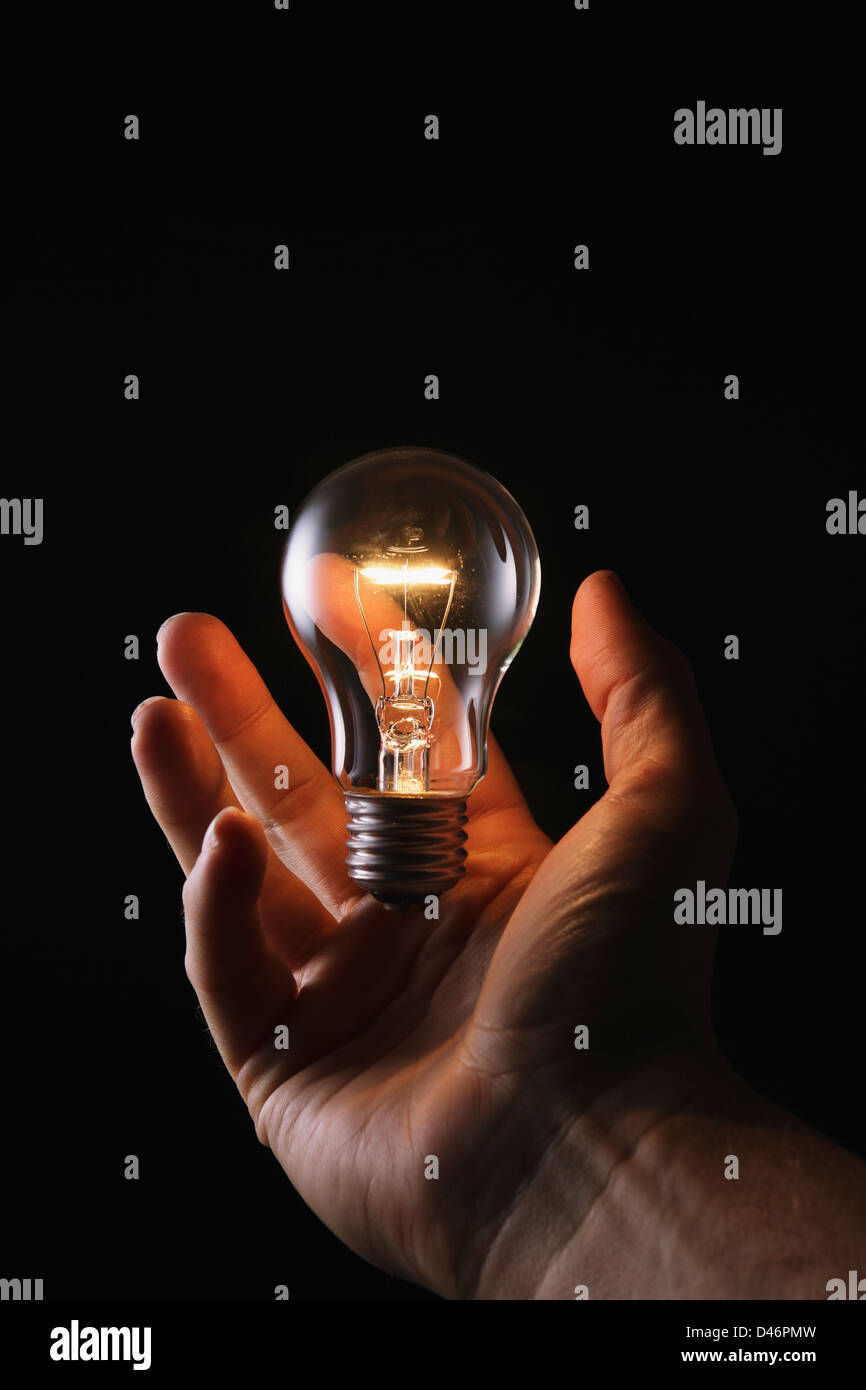 Hand With Light Bulb Stock Photo - Alamy