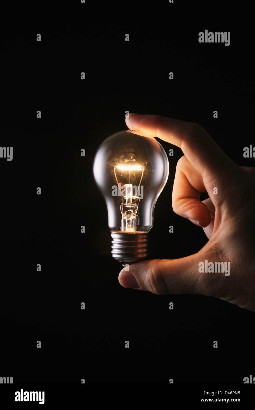 Hand With Light Bulb Stock Photo - Alamy