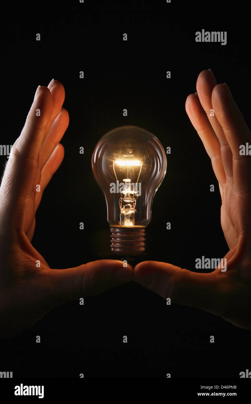 Hands With Light Bulb Stock Photo - Alamy