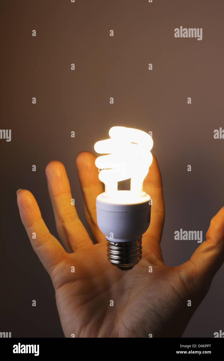 Hand With Compact Fluorescent Light Bulb Stock Photo - Alamy