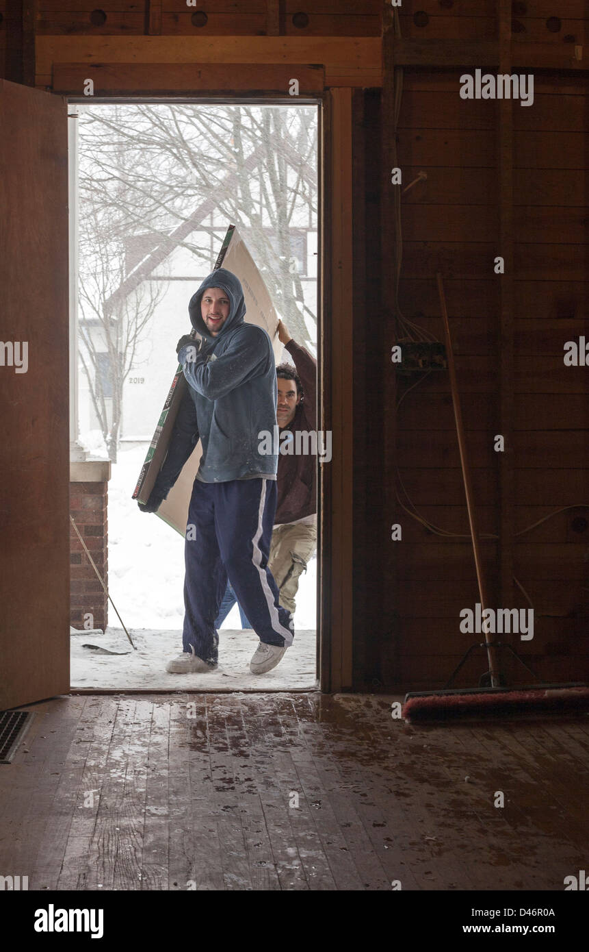 New house construction workers carrying hi-res stock photography and ...
