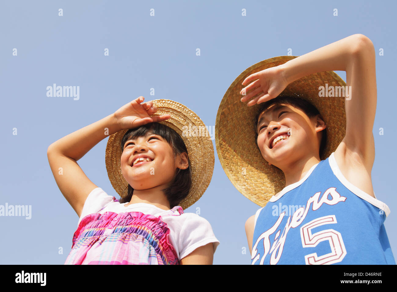 Children With Straw Hats Looking at the Sky Stock Photo - Alamy