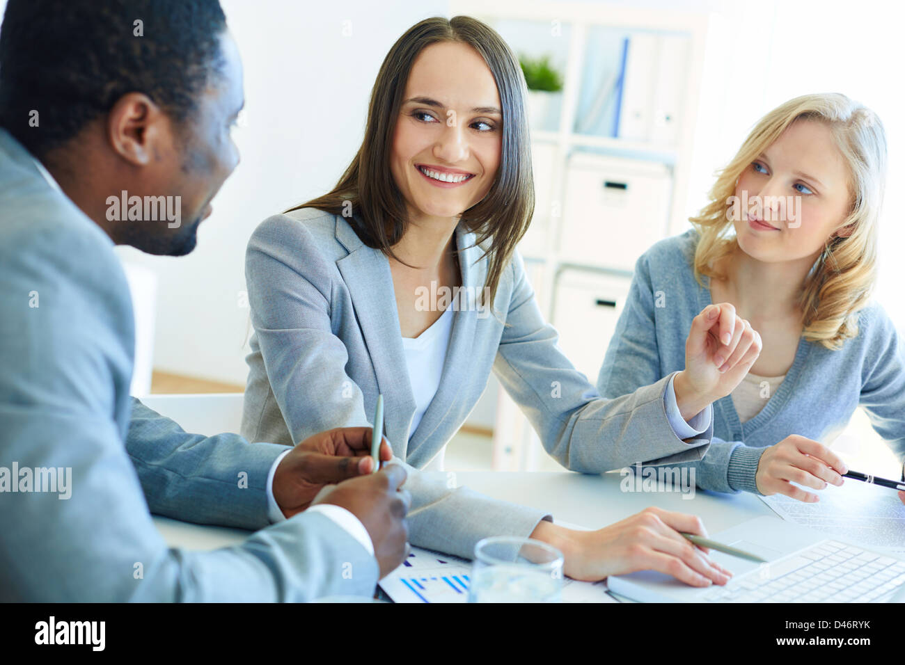 Group of friendly businesspeople interacting at meeting Stock Photo - Alamy