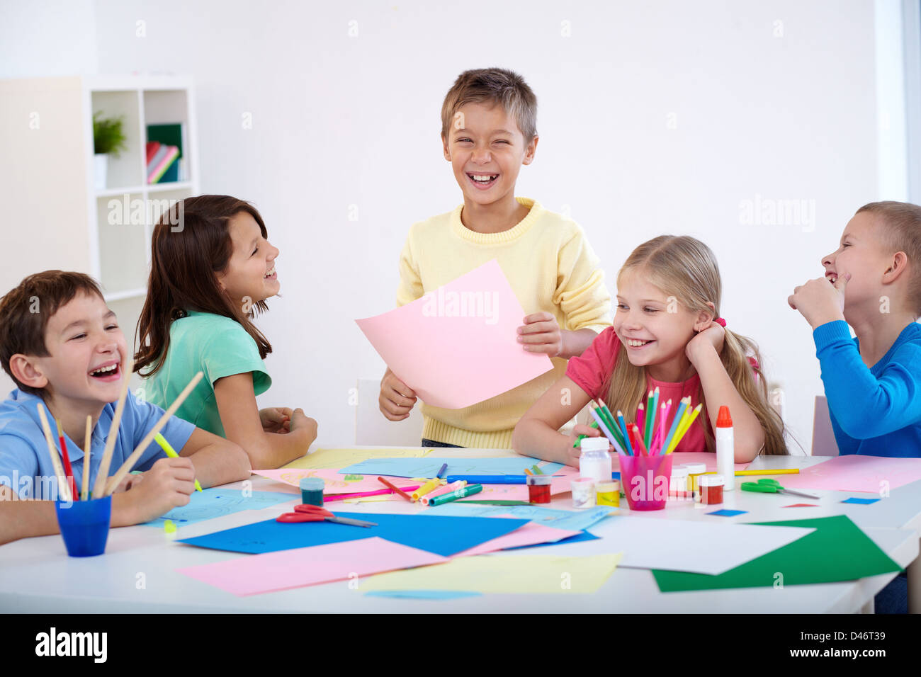 Little boy and his friends laughing in classroom Stock Photo - Alamy