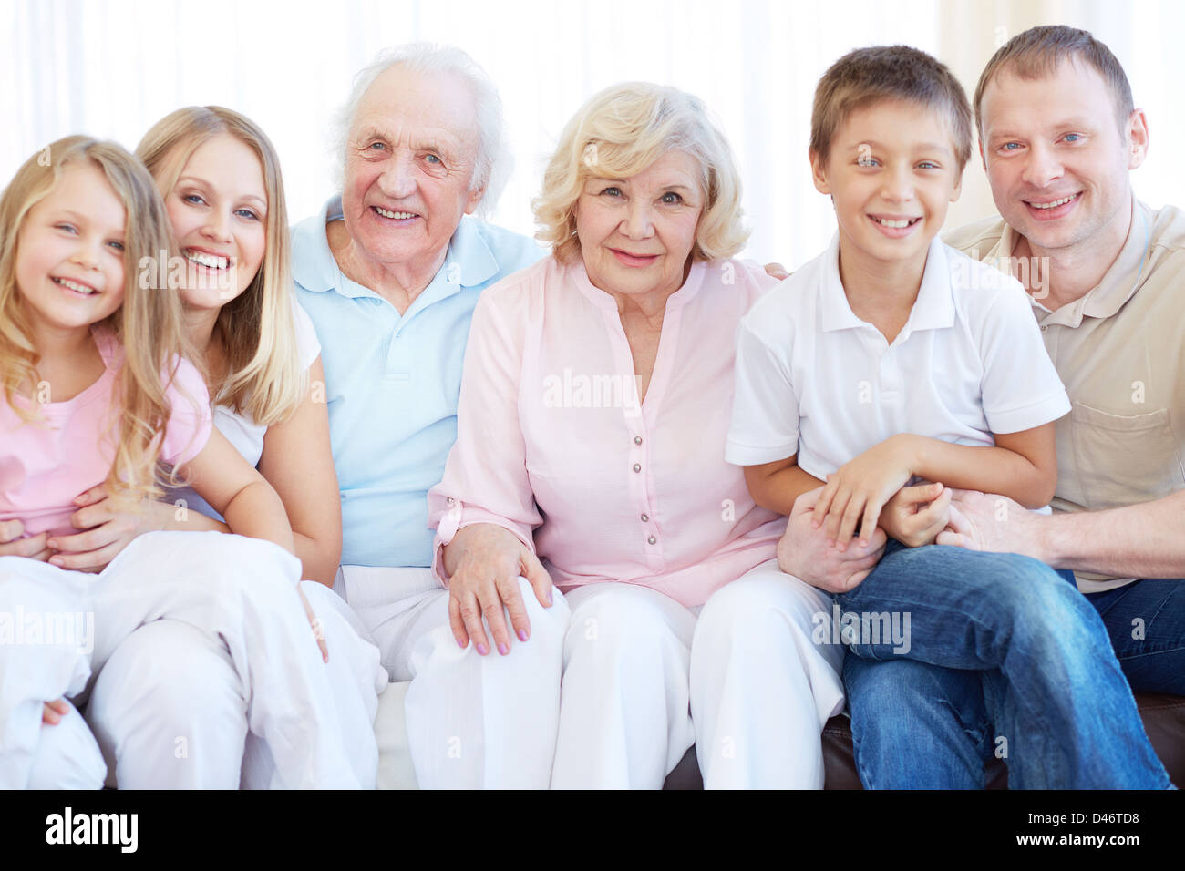 Portrait of senior and young couples with their children looking at ...