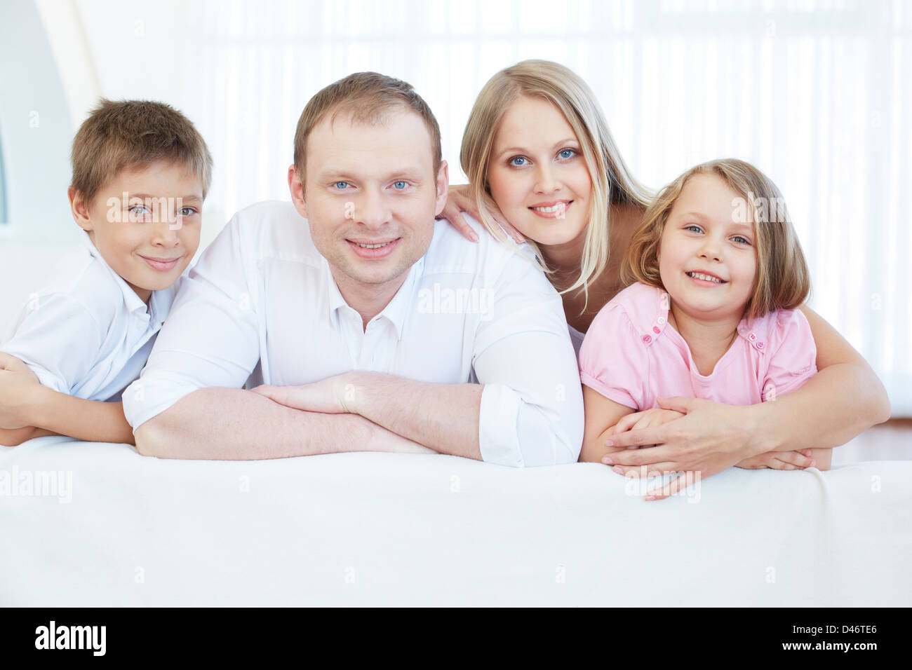 Portrait of happy parents with two children having rest at home Stock ...