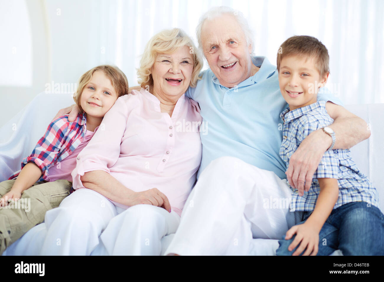 Portrait of happy grandparents with two granndchildren having rest at ...