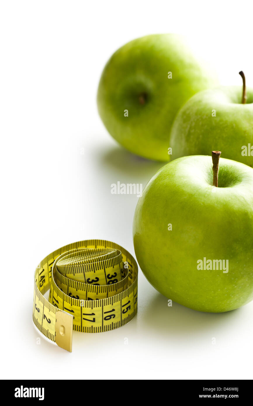 green apple and measuring tape on white background Stock Photo - Alamy