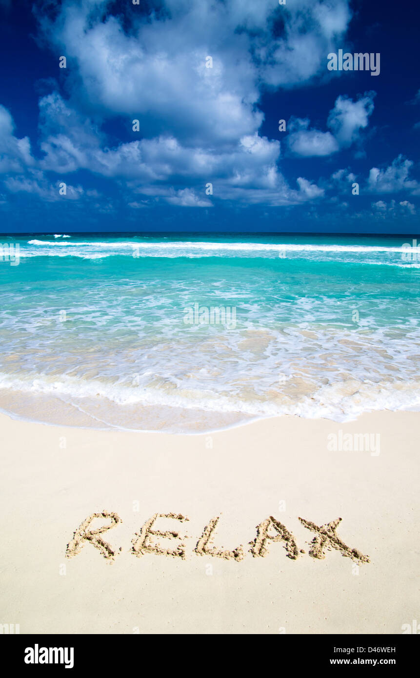 Word Relax on sand beach Stock Photo - Alamy