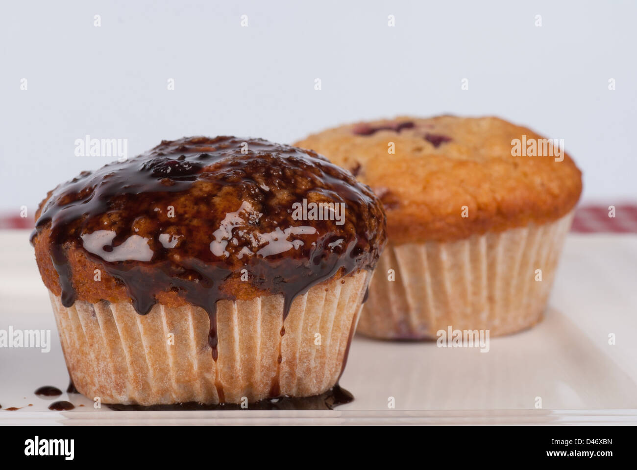 Two homemade muffins, one with a sweet chocolate coating Stock Photo ...