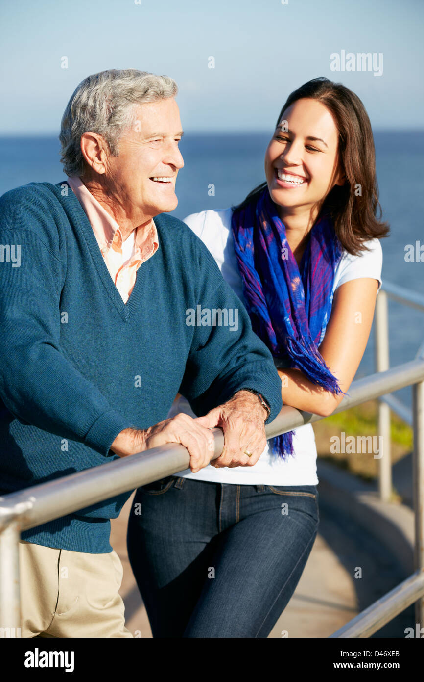 Senior Man With Adult Daughter Looking Over Railing At Sea Stock Photo ...