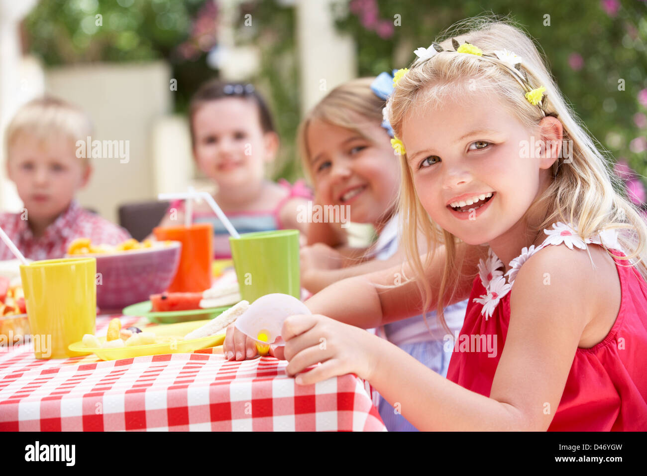 Group Of Children Enjoying Outdoor Tea Party Stock Photo - Alamy