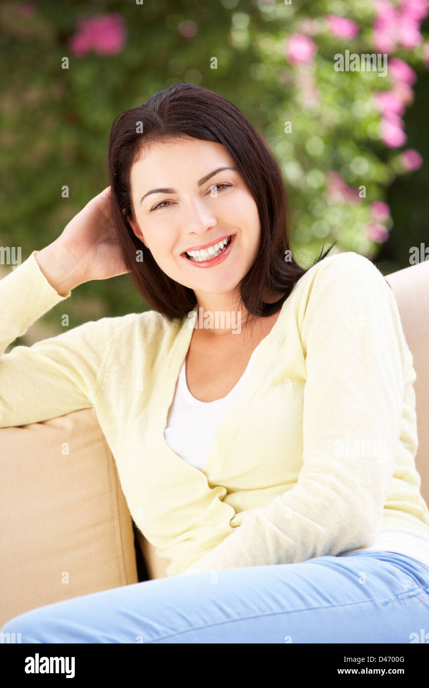 Woman Relaxing On Sofa At Home Stock Photo - Alamy