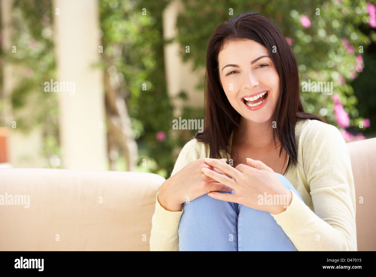 Woman Relaxing On Sofa At Home Stock Photo - Alamy