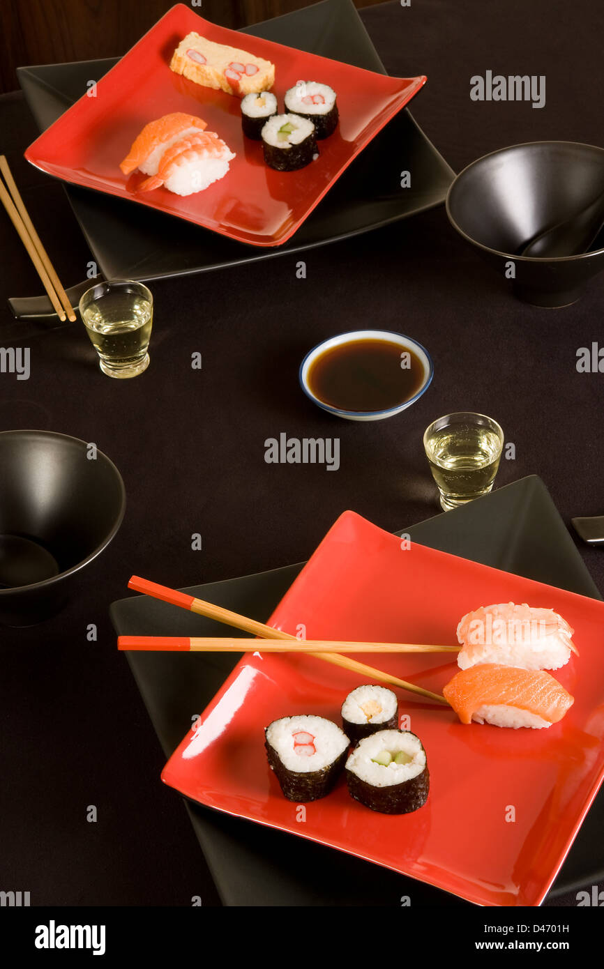 Japanese dinner setting with sushi, chopsticks and sake Stock Photo - Alamy
