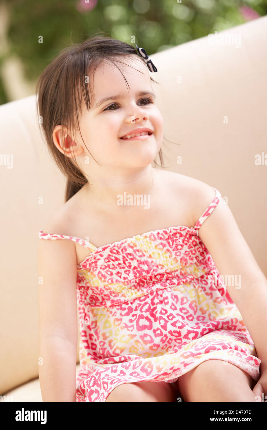 Happy Girl Sitting On Sofa Stock Photo - Alamy