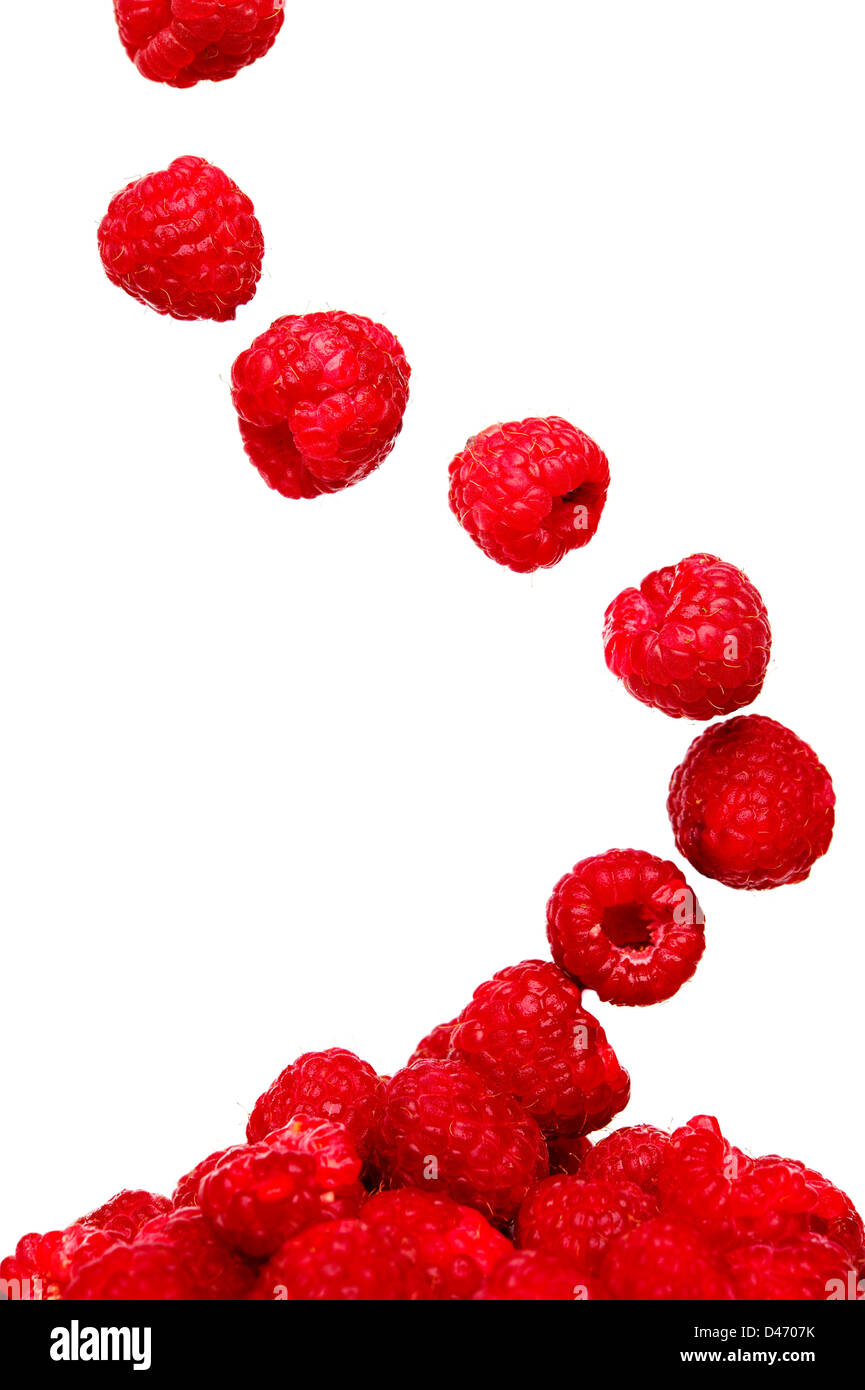 Raspberries falling into a pile isolated on a white background Stock ...