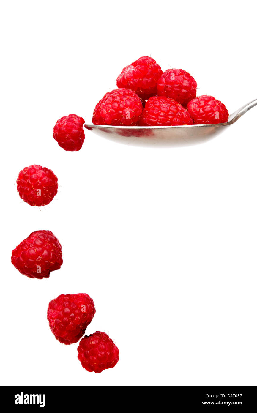 Raspberries falling from a spoon isolated on a white background Stock ...