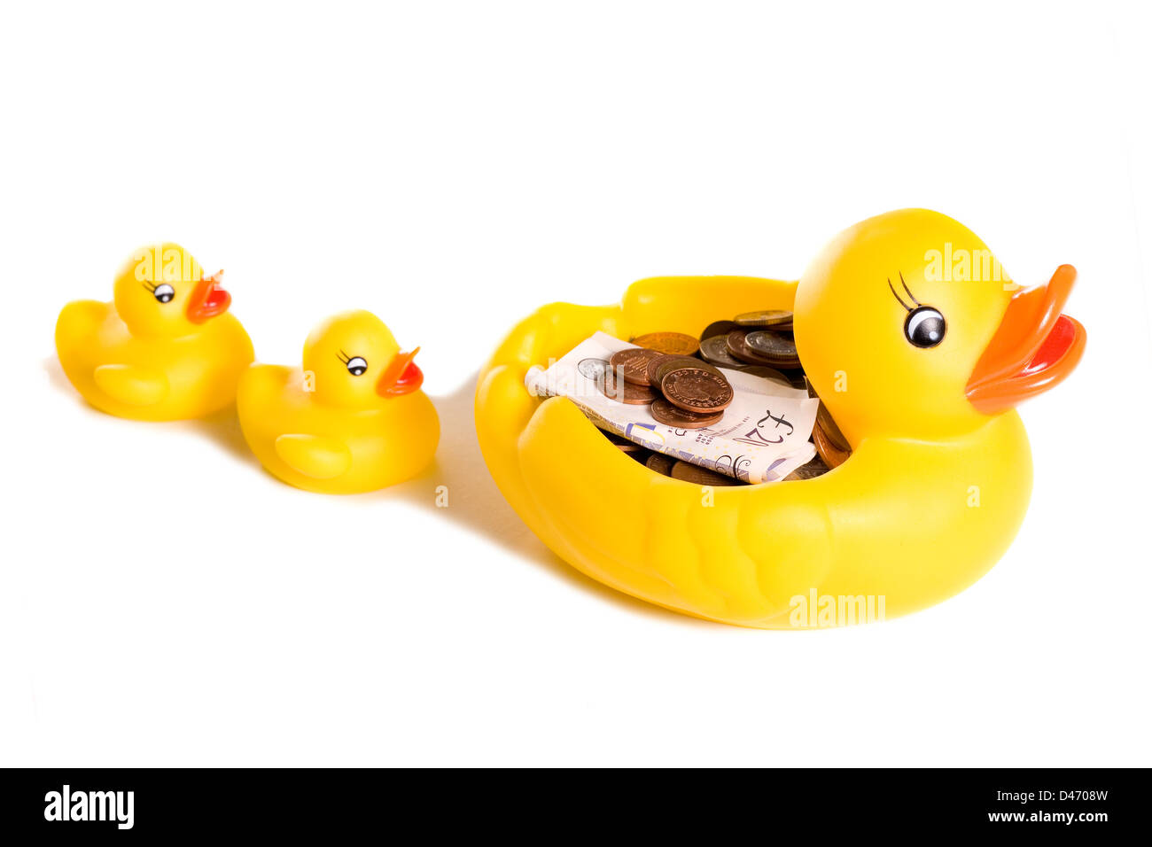 rubber ducks with money studio cutout Stock Photo - Alamy