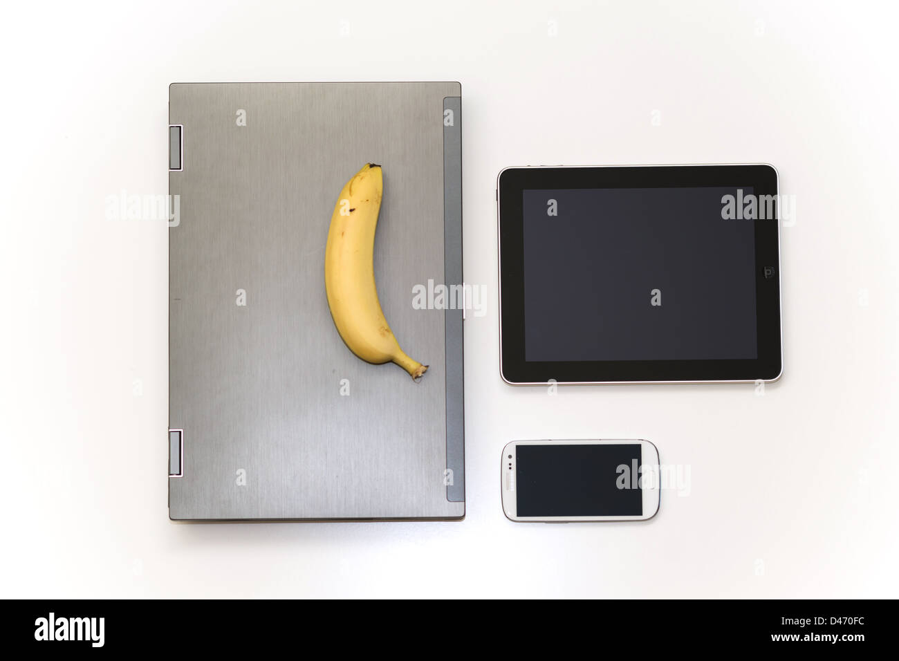Modern electronics and banana Stock Photo - Alamy