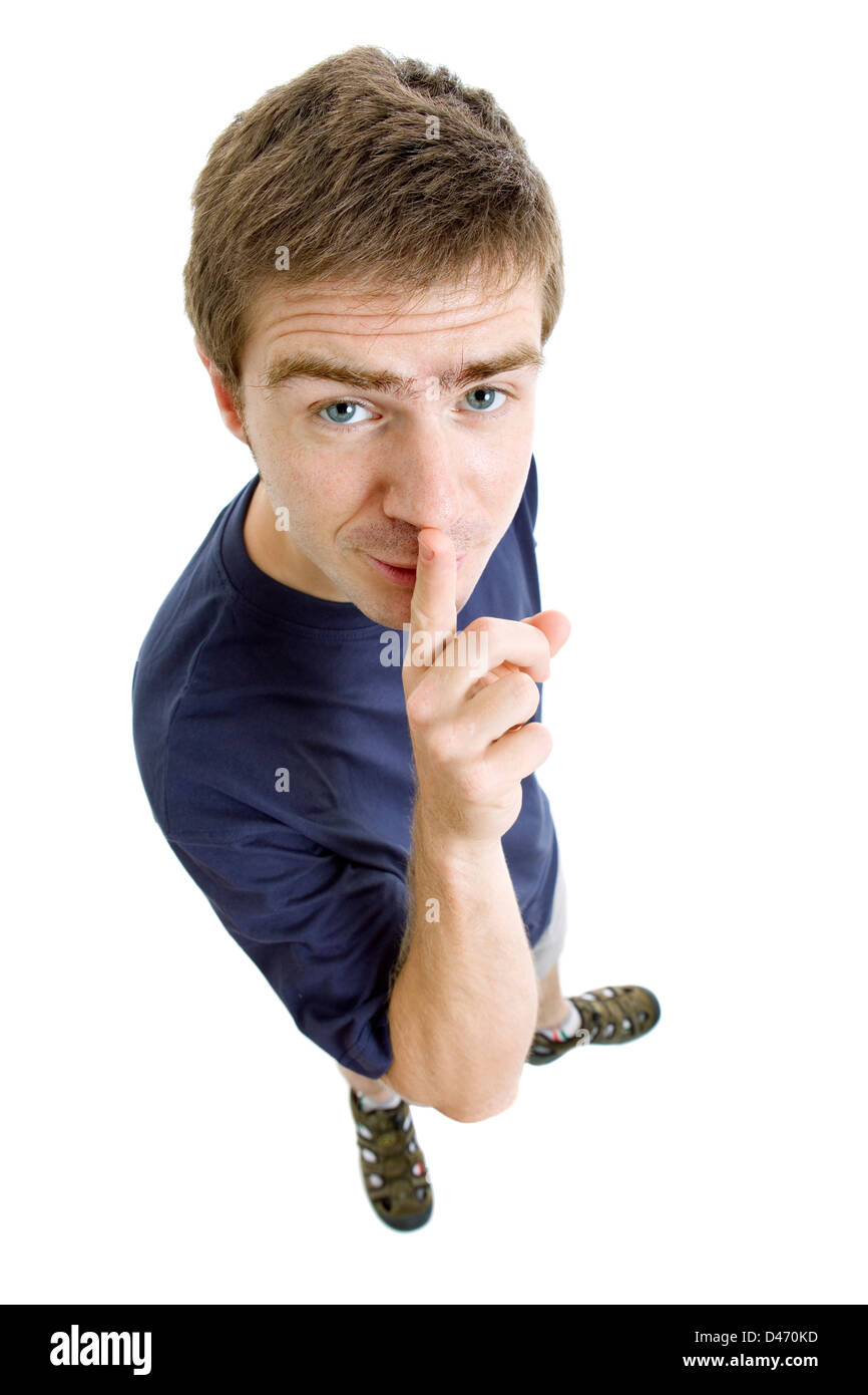 young casual man full body with his finger on lips Stock Photo - Alamy