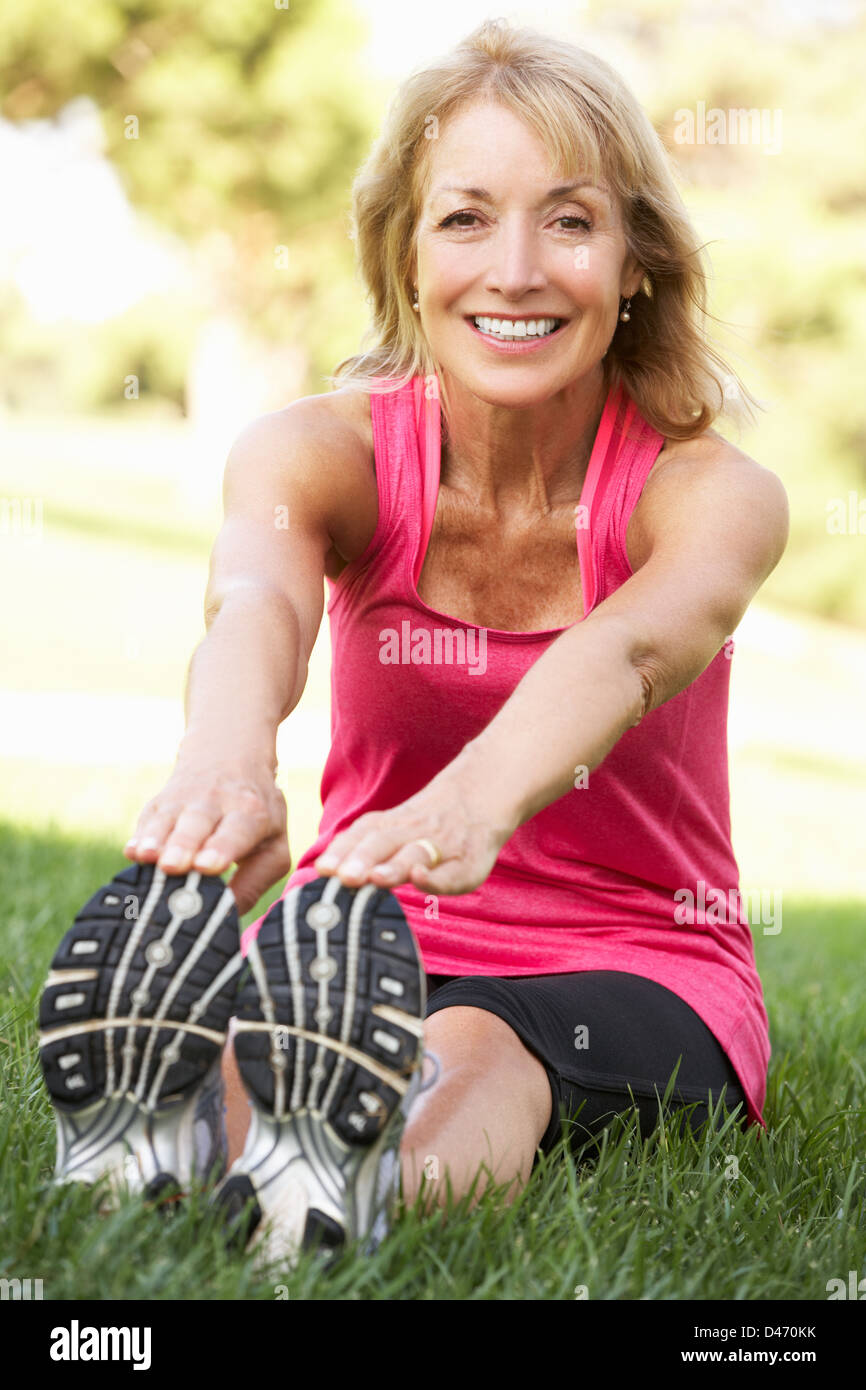 Senior Woman Exercising In Park Stock Photo - Alamy