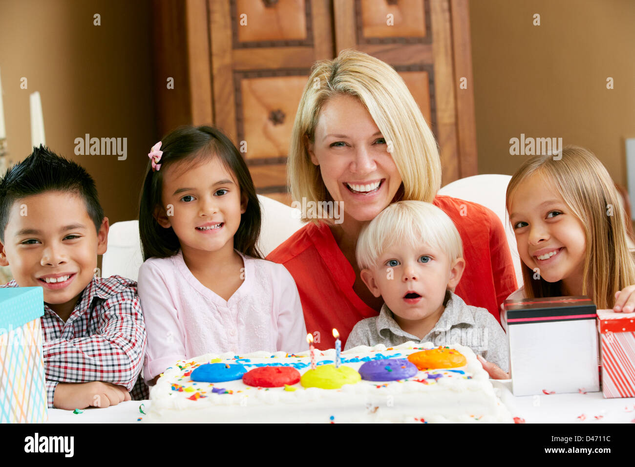 Mother Celebrating Child's Birthday With Friends Stock Photo - Alamy