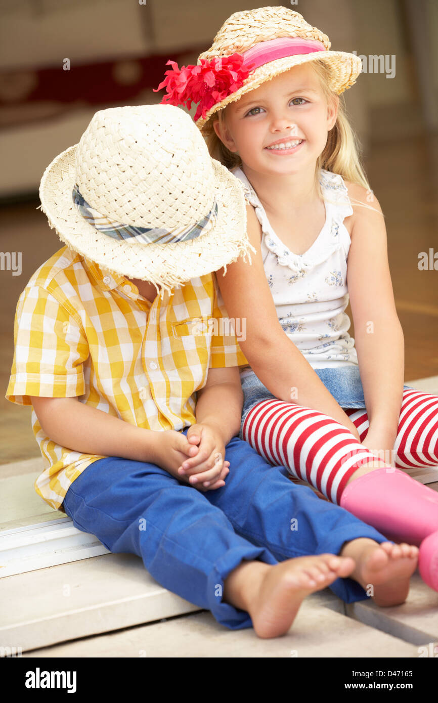 Two Children Sitting Outside House Stock Photo - Alamy
