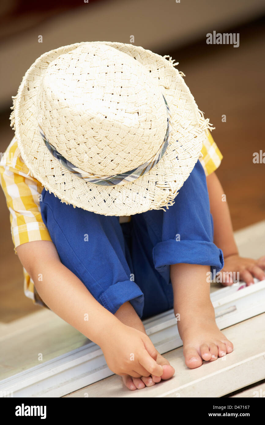 Boy Sitting Outside House Stock Photo - Alamy