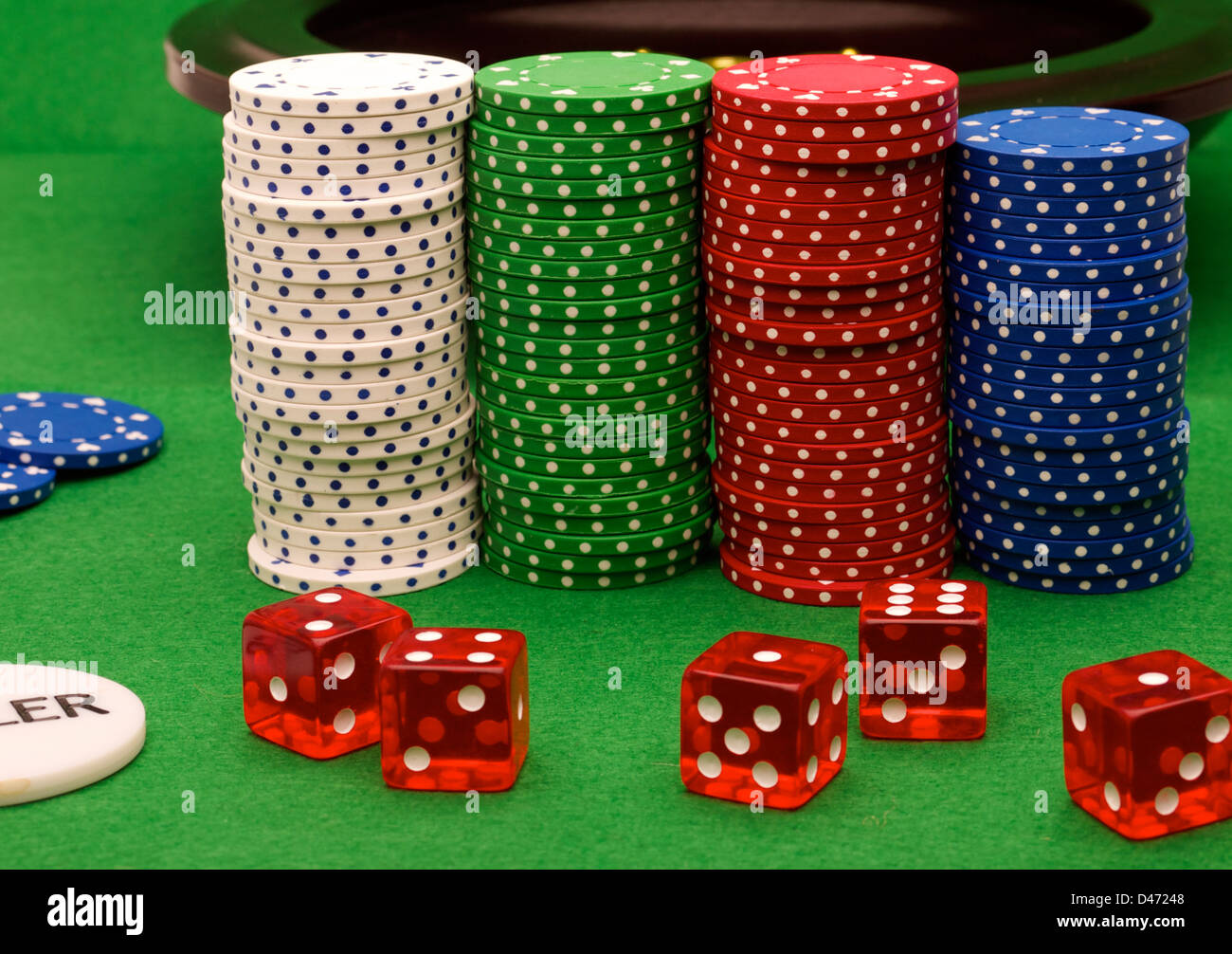 Stacked chips and dice on a green velvet background Stock Photo - Alamy