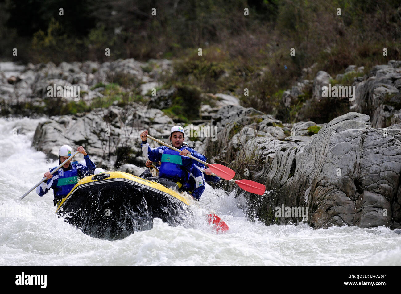 Young tourists practice rafting with a guide in Sella river in an ...