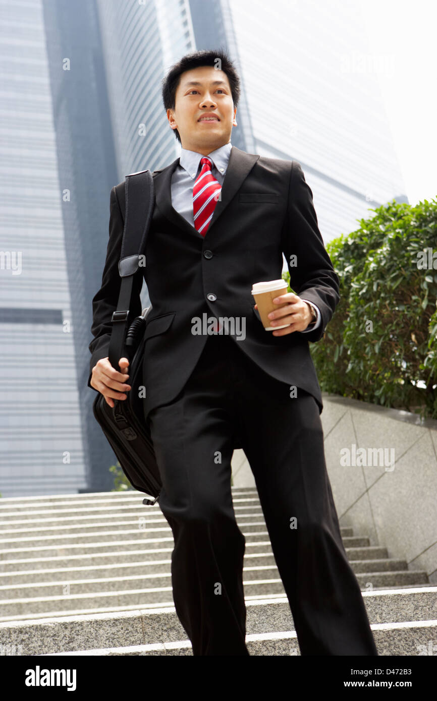 Chinese Businessman Rushing Down Steps Carrying Bag And Takeaway Coffee ...