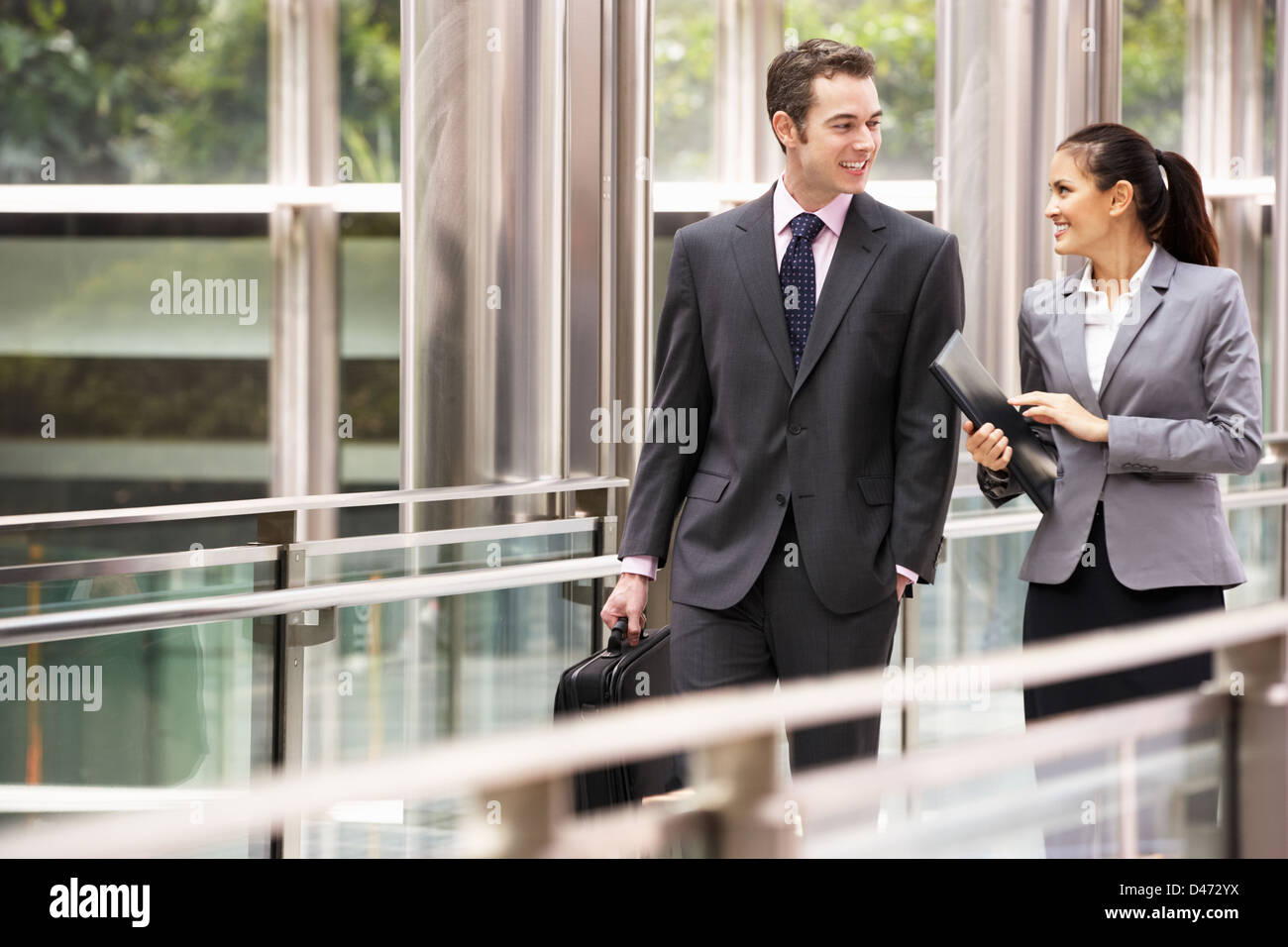 Two Business Colleagues Having Discussion Whilst Walking Outside Office ...